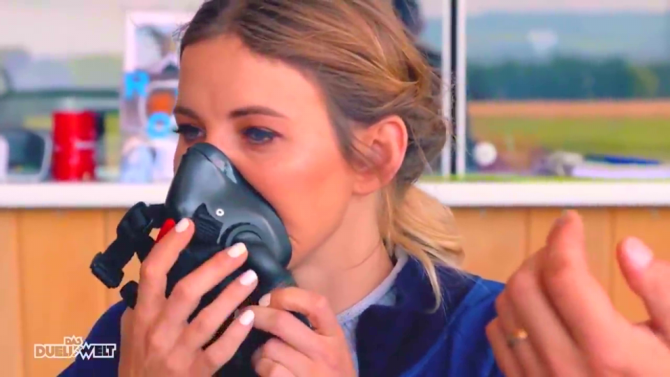 Female game show participant jumps out of a plane with an oxygen mask ...