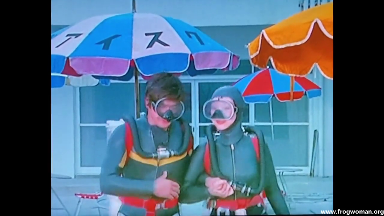 Japanese vintage frogwoman wearing a perfect wetsuit on the surface ...