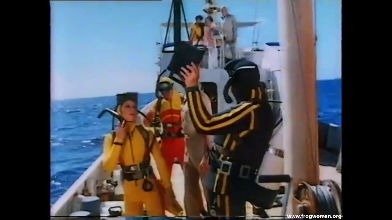 One female diver and 2 guys explore the outer hull off a sunken ...